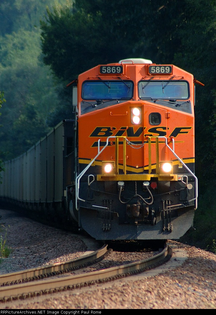 BNSF 5869 works a westbound hopper down grade on the Creston Sub